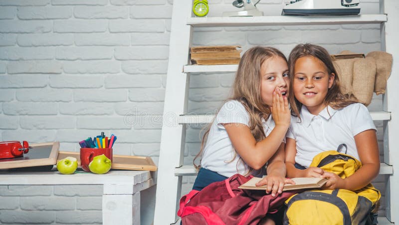 Happy School Girls Reading a Book in Library at School. Stock Image ...