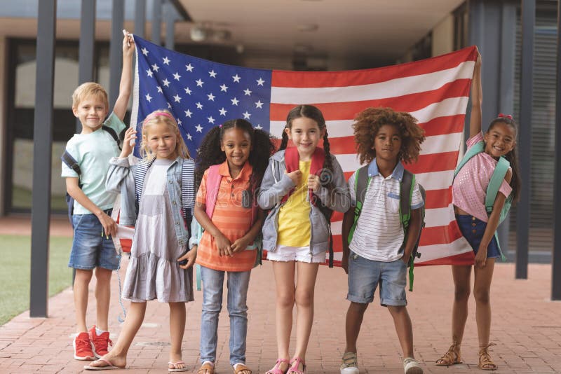Happy School Students Standing in Corridor while Holding American Flag ...