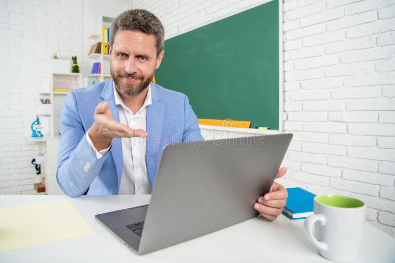 Happy School Teacher in Classroom with Computer at Blackboard Stock ...