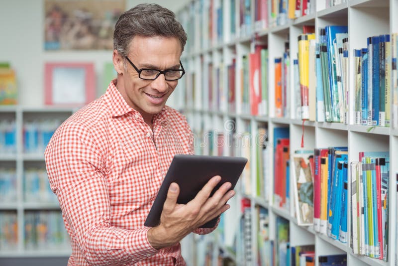 Happy School Teacher Using Digital Tablet in Library Stock Image ...