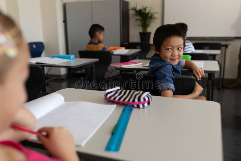 Happy Schoolboy Looking Back In Classroom Stock Photo - Image of ...