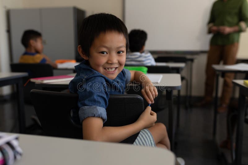 Happy Schoolboy Looking Back in Classroom Stock Image - Image of ...