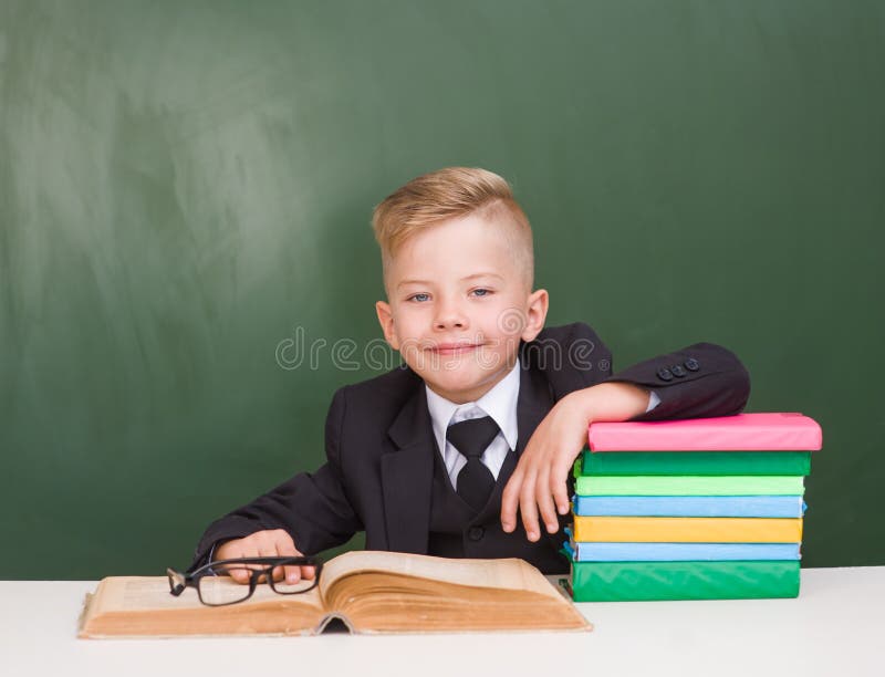 Happy Schoolboy in a Suit in Classroom Stock Photo - Image of glasses ...