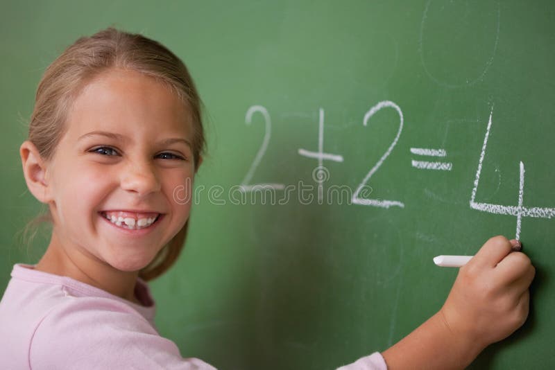 Happy Schoolgirl Writing a Number Stock Image - Image of learning ...