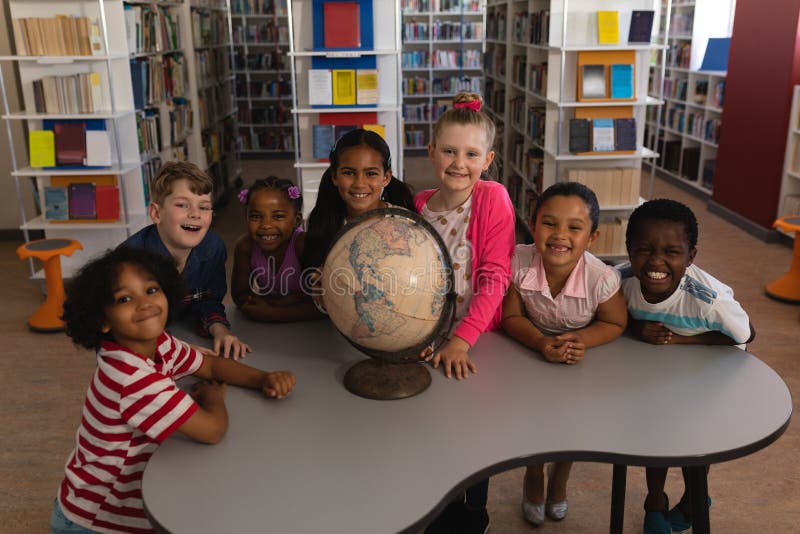 Happy Schoolkids with Globe Looking at Camera in School Library Stock ...
