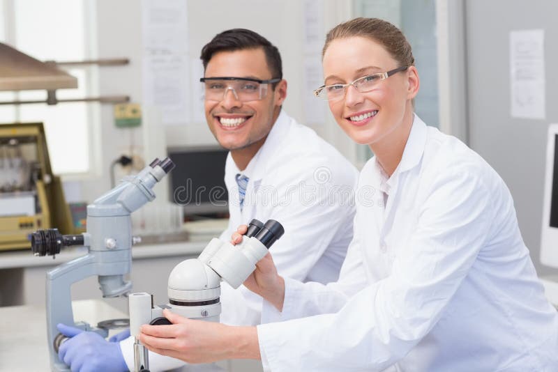 Happy Scientists Using Microscope Stock Photo - Image of microscope ...