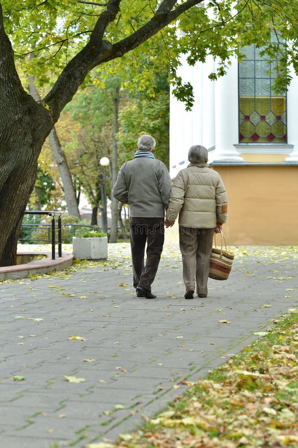 Happy Senior Couple in Autumn Park Walking Stock Image - Image of ...