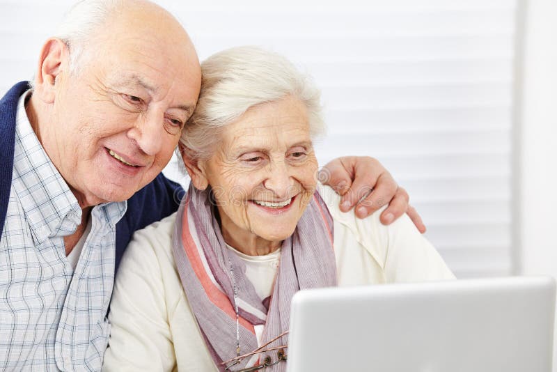 Amused Senior Couple Using a Laptop Computer Stock Image - Image of ...