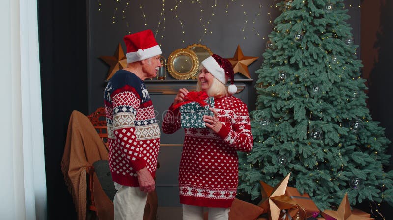 Grandfather Gifting Christmas Present Box To Surprised Grandmother ... Grandfather Gifting Christmas Present Box To Surprised Grandmother ...