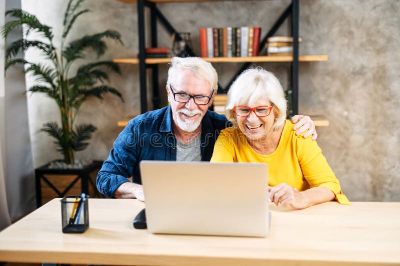 A Happy Senior Couple is Using the Laptop Indoor Stock Image - Image of ...