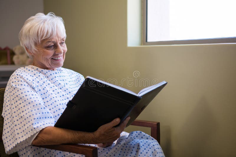 Happy Senior Patient Reading Book Stock Image - Image of ageing, chair ...
