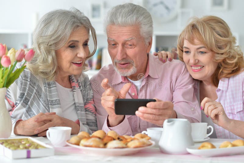 Happy Senior People with Smartphone Drinking Tea Stock Image - Image of ...
