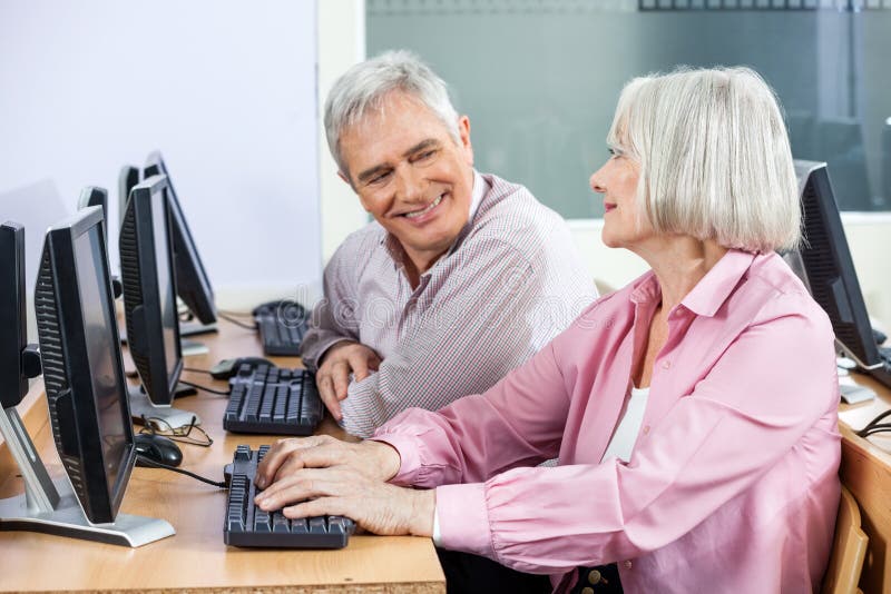 Happy Senior Students Communicating in Computer Class Stock Photo ...