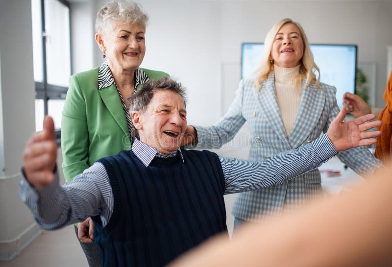 Happy Senior Students Meeting and Hugging in Classroom. Stock Photo ...