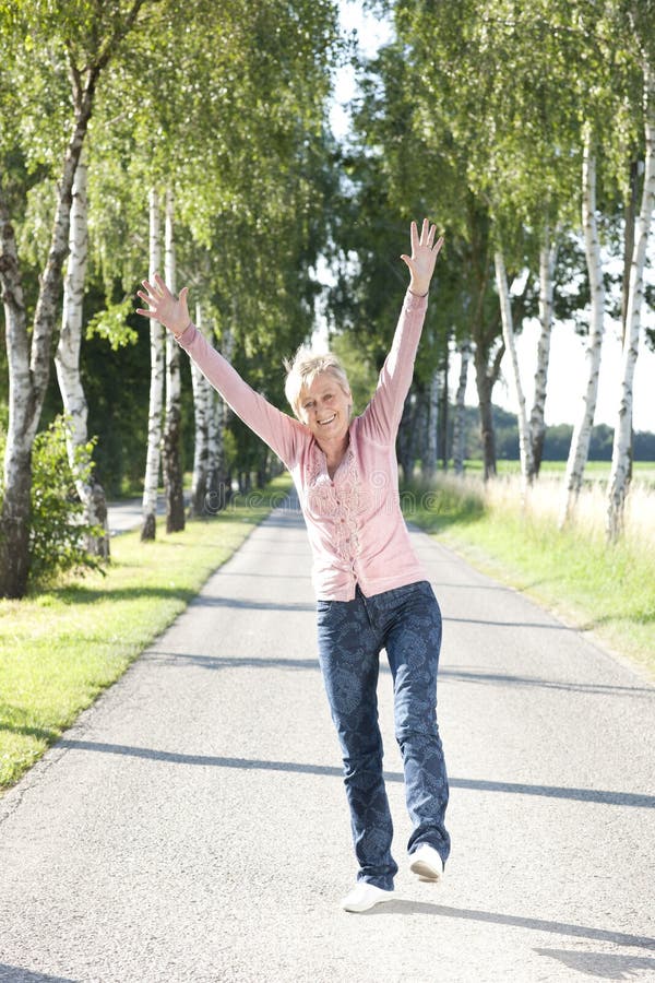 Happy Senior Woman Active in Nature Stock Image - Image of outstretched ...