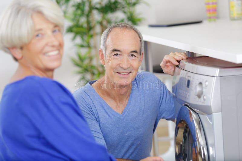 Happy Senior Woman Smiling while Man in Using Washing-machine Stock ...