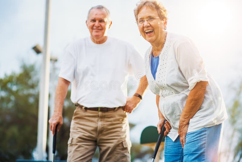 Happy Seniors Playing Mini Golf Stock Photo - Image of people, family ...