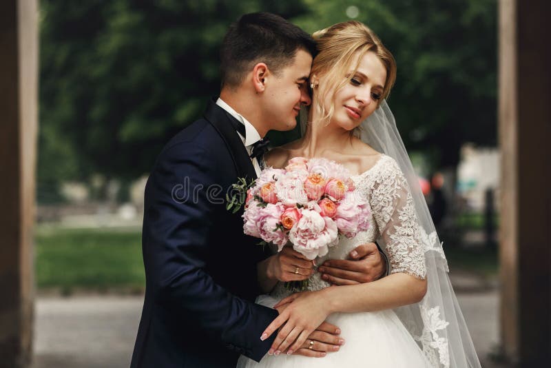 Happy Sensual Handsome Groom And Blonde Beautiful Bride In White Stock