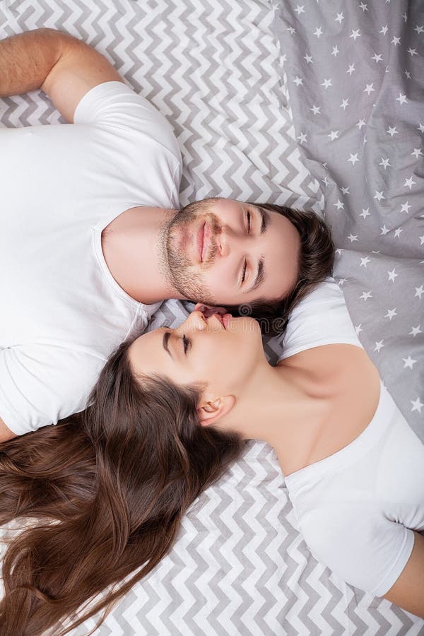 Happy Sensual Young Couple Lying in Bed Together Stock Photo - Image of ...
