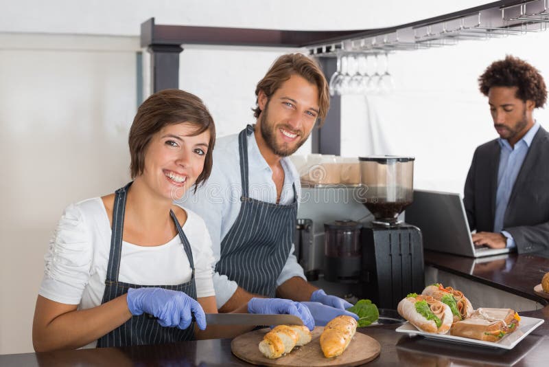 Happy Servers Preparing Sandwiches Together Stock Photo - Image of ...
