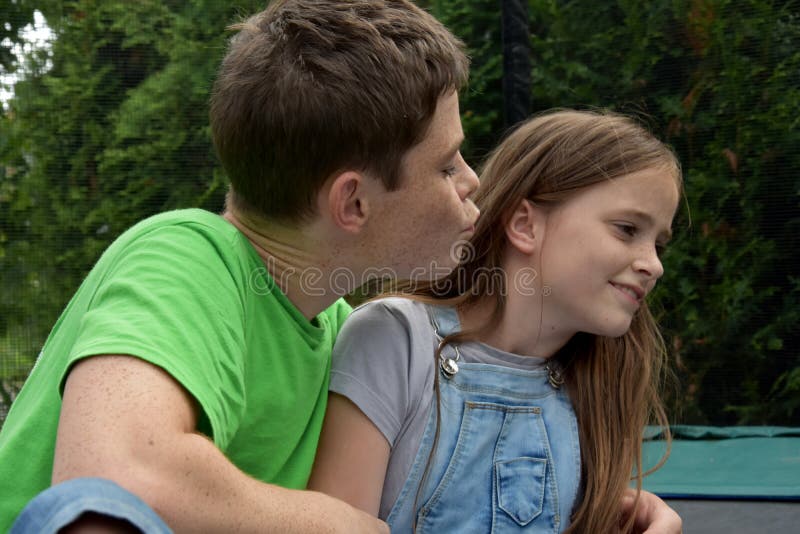 Happy Siblings in the Garden in a Friendly Embrace Stock Image - Image ...
