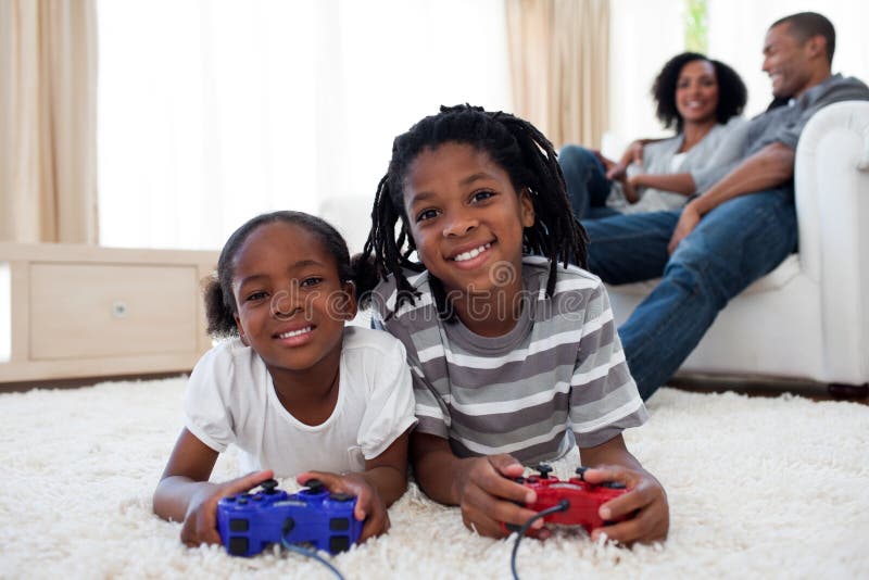 Siblings Playing Video Games Together Stock Photo - Image of lying ...