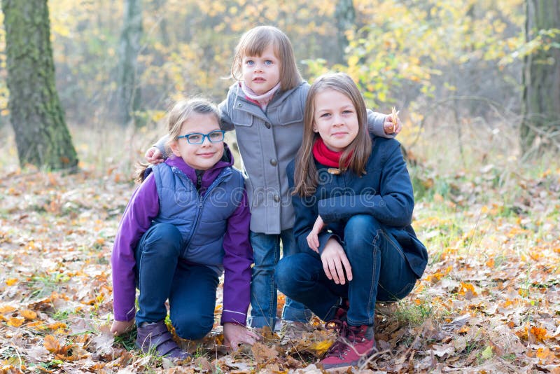 Happy Siblings - Three Sisters in the Autumnal Forest Smiling Stock ...
