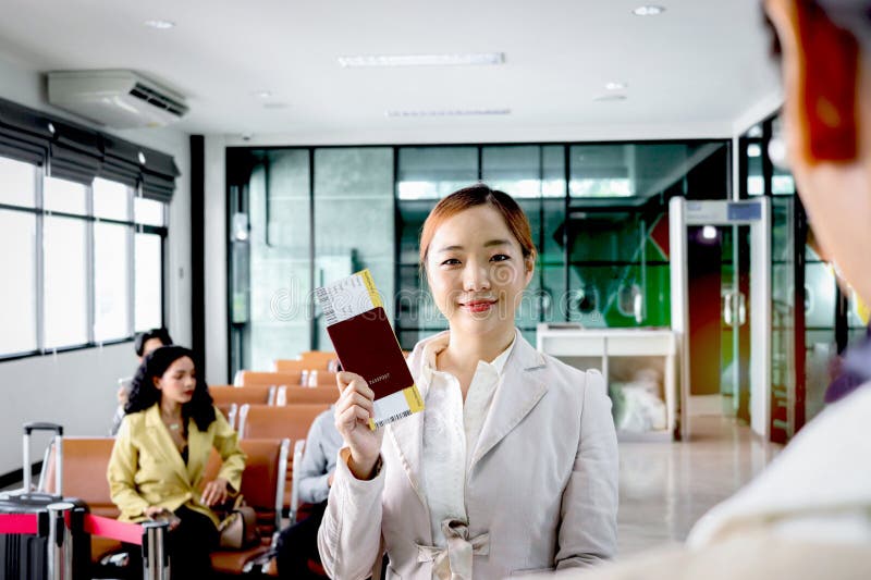 Happy Smiling Beautiful Asian Woman Traveler Showing Passport At