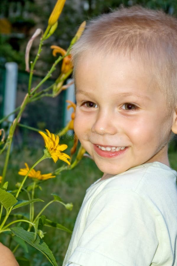 Happy Smiling Boy with Yellow Flowers Stock Photo - Image of pretty ...