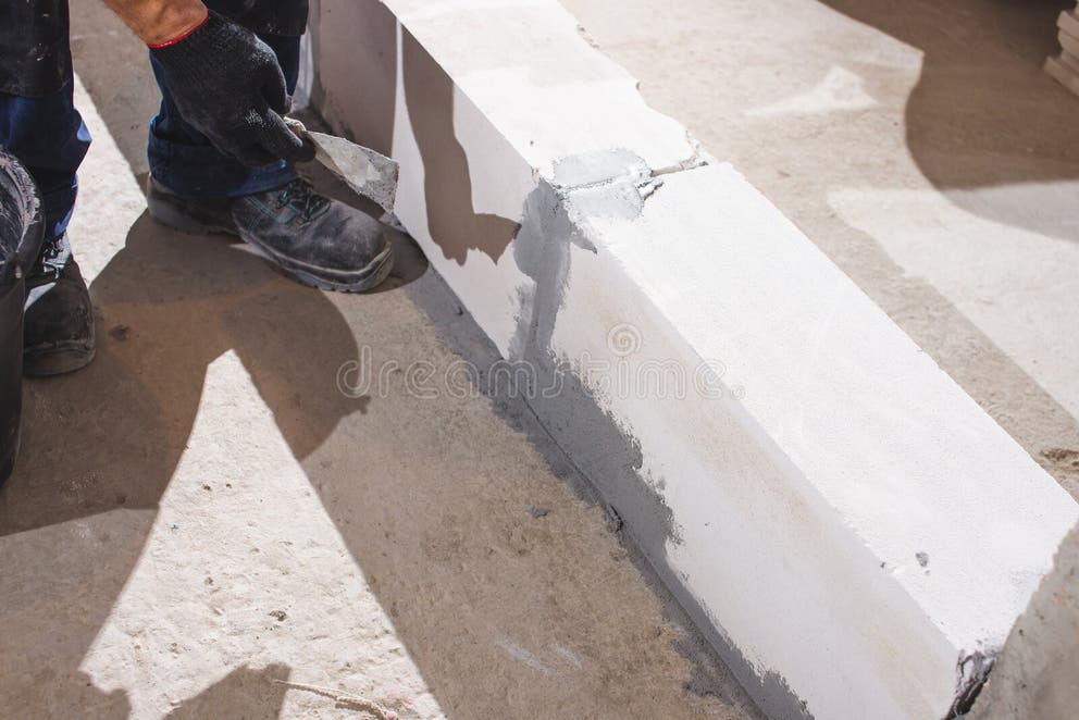 Happy Smiling Construction Worker Constructing or Building Wall by ...
