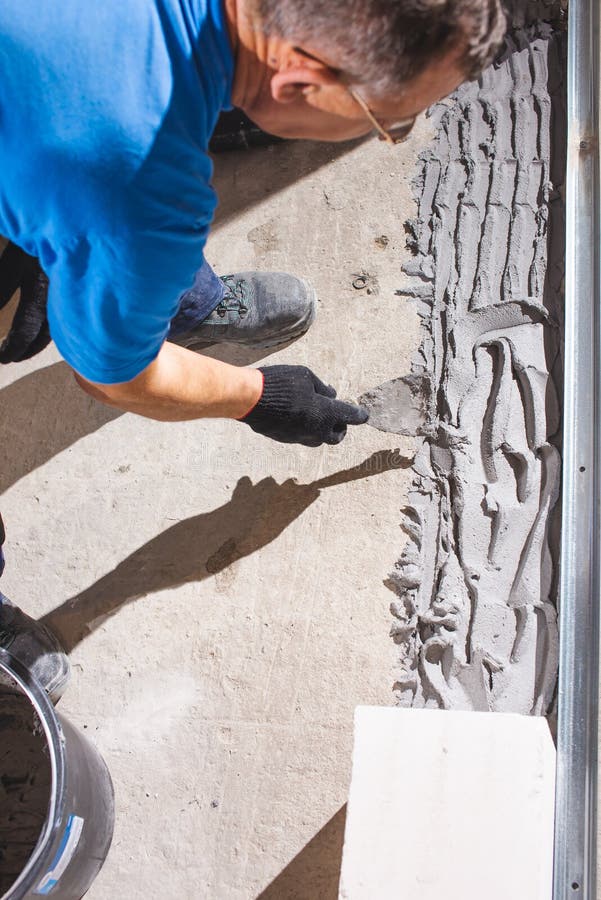 Happy Smiling Construction Worker Constructing or Building Wall by ...