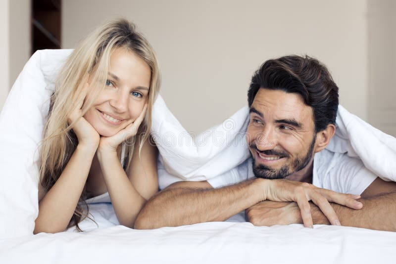 Happy Smiling Couple Lying on Bed in Bedroom Stock Image - Image of ...
