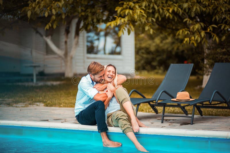 Smiling Couple Sitting by the Pool Stock Image - Image of life ...