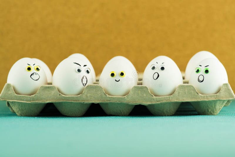 Happy Smiling Egg among Angry Eggs on Paper Tray. Positive Attitude ...