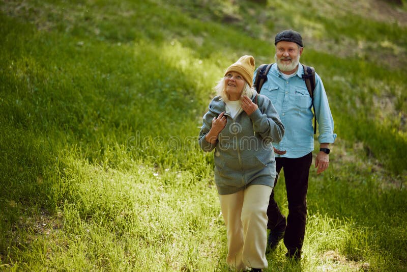 Happy Smiling Elderly Couple Man And Woman Holding Hands Walk