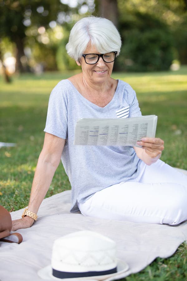 Happy Smiling Elderly Woman Reading Magazine Stock Photo - Image of ...