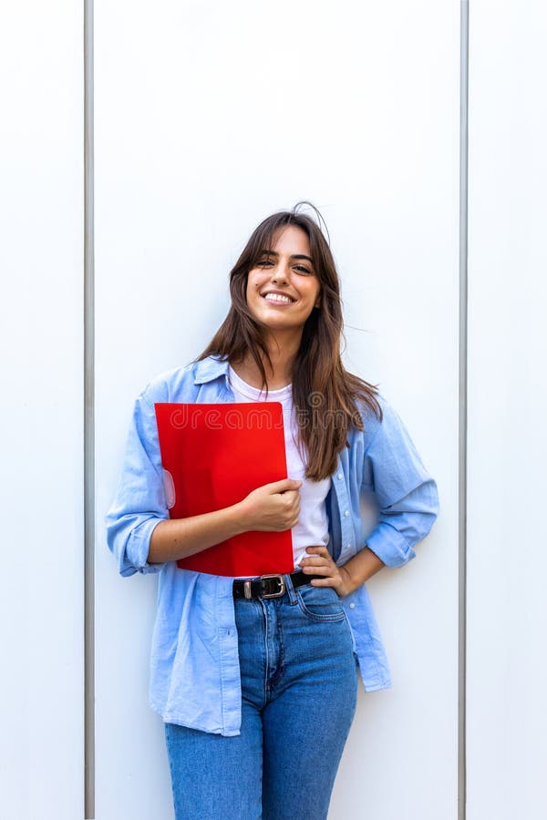 Happy, Smiling Female College Student Looking at Camera Holding Red ...
