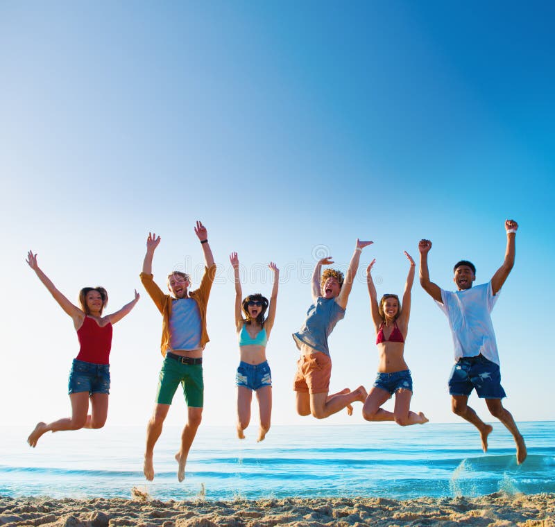 Happy Smiling Friends Jumping at the Beach Stock Photo - Image of smile ...