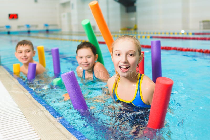 Happy and Smiling Group of Children Learning To Swim with Pool Noodle ...
