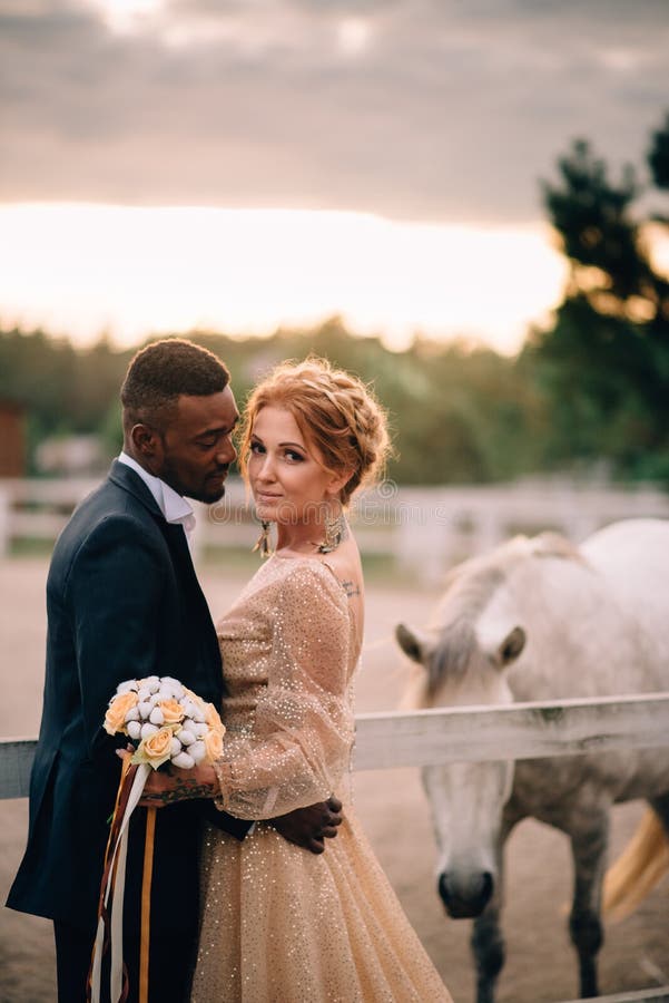 Happy Smiling Newlyweds Standing on Ranch Surrounded by Horses. Stock ...