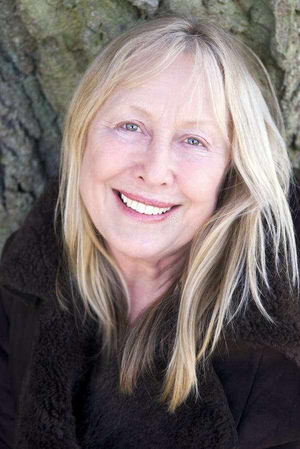 Attractive Older Woman Leaning Against Tree Smiling Stock Photos - Free ...