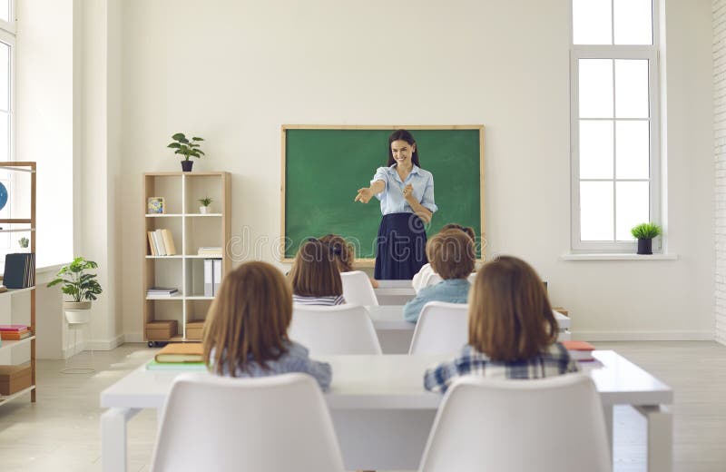 Happy Smiling School Teacher Asks Her Little Elementary Student a ...