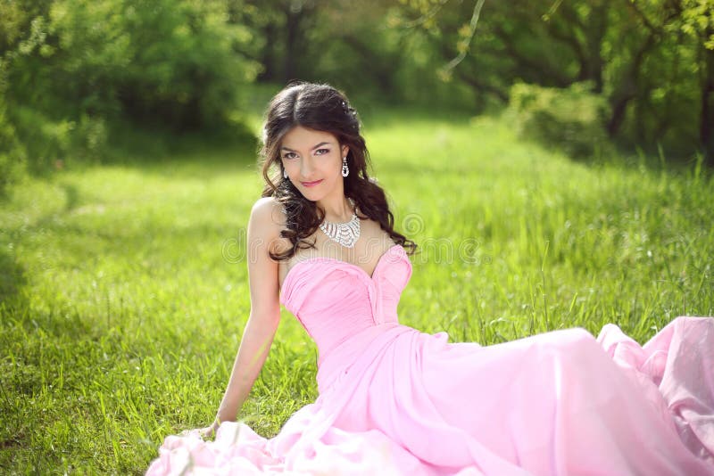 Happy Smiling Young Bride Girl Dreaming And Resting On Green Grass At