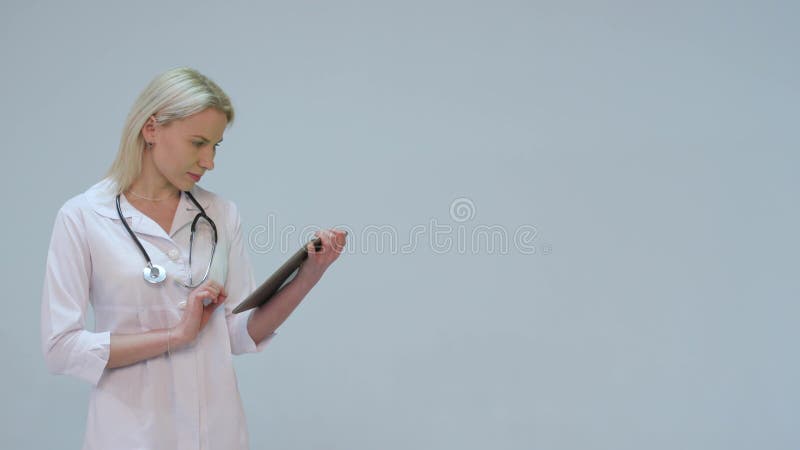 Happy and Smiling Young Doctor Typing Text on the Tablet Stock Photo ...