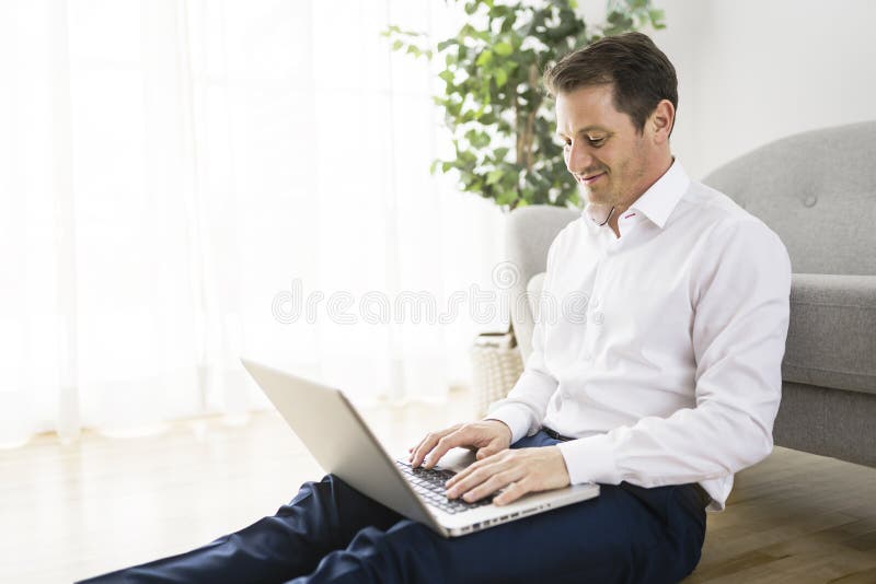 Happy Smiling Young Man Watching and Working on Computer Laptop at Home ...