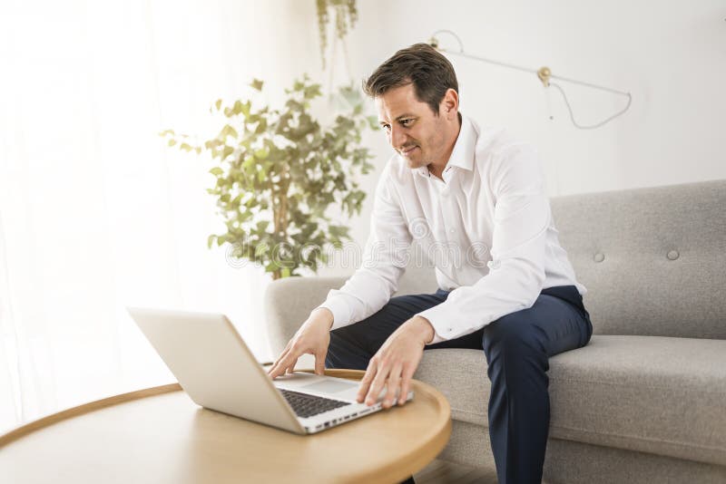 Happy Smiling Young Man Watching and Working on Computer Laptop at Home ...