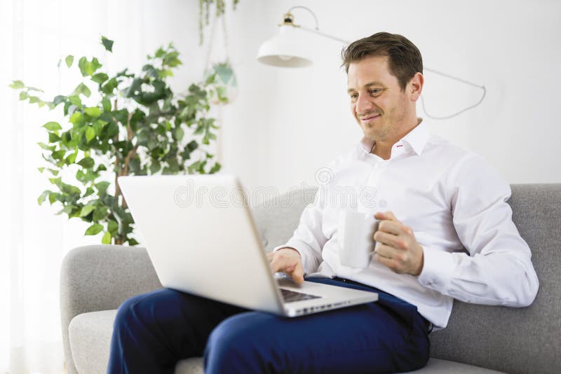 Happy Smiling Young Man Watching and Working on Computer Laptop at Home ...