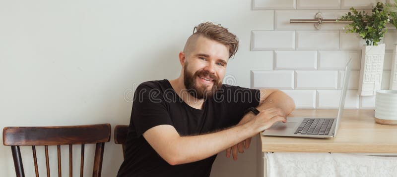Happy Smiling Young Man Watching and Working on Computer Laptop at Home ...