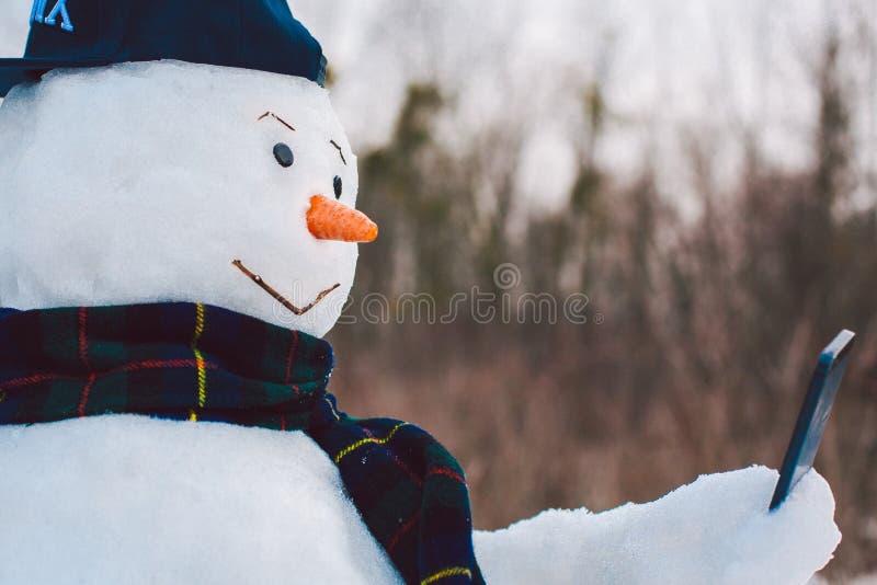 Snowman using smart phone stock photo. Image of emotions - 160635466