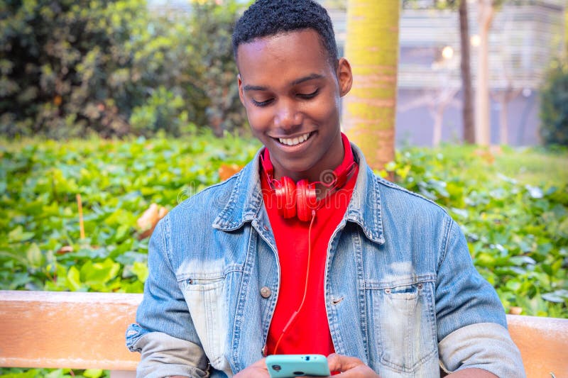 Happy Student African American Man Browsing the Internet Using a Mobile ...